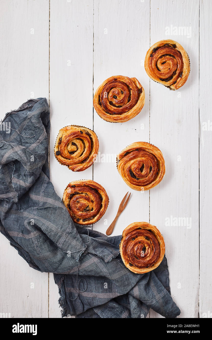 Fresh danish pastry with raisins on wood background.Tasty sweet bakery ...