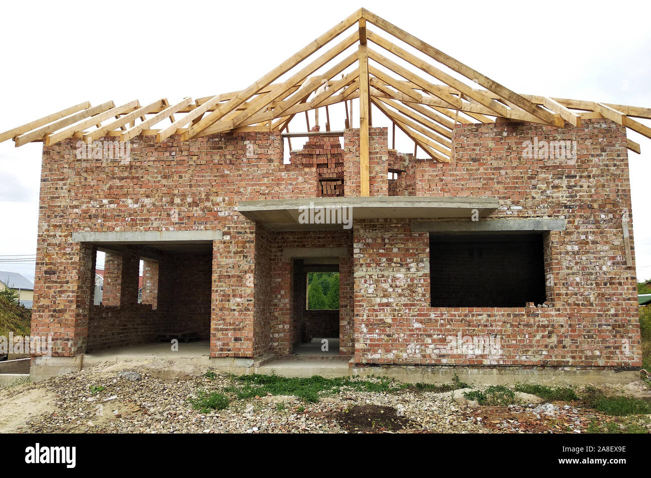 Brick residential house with wooden roof under construction Stock Photo ...
