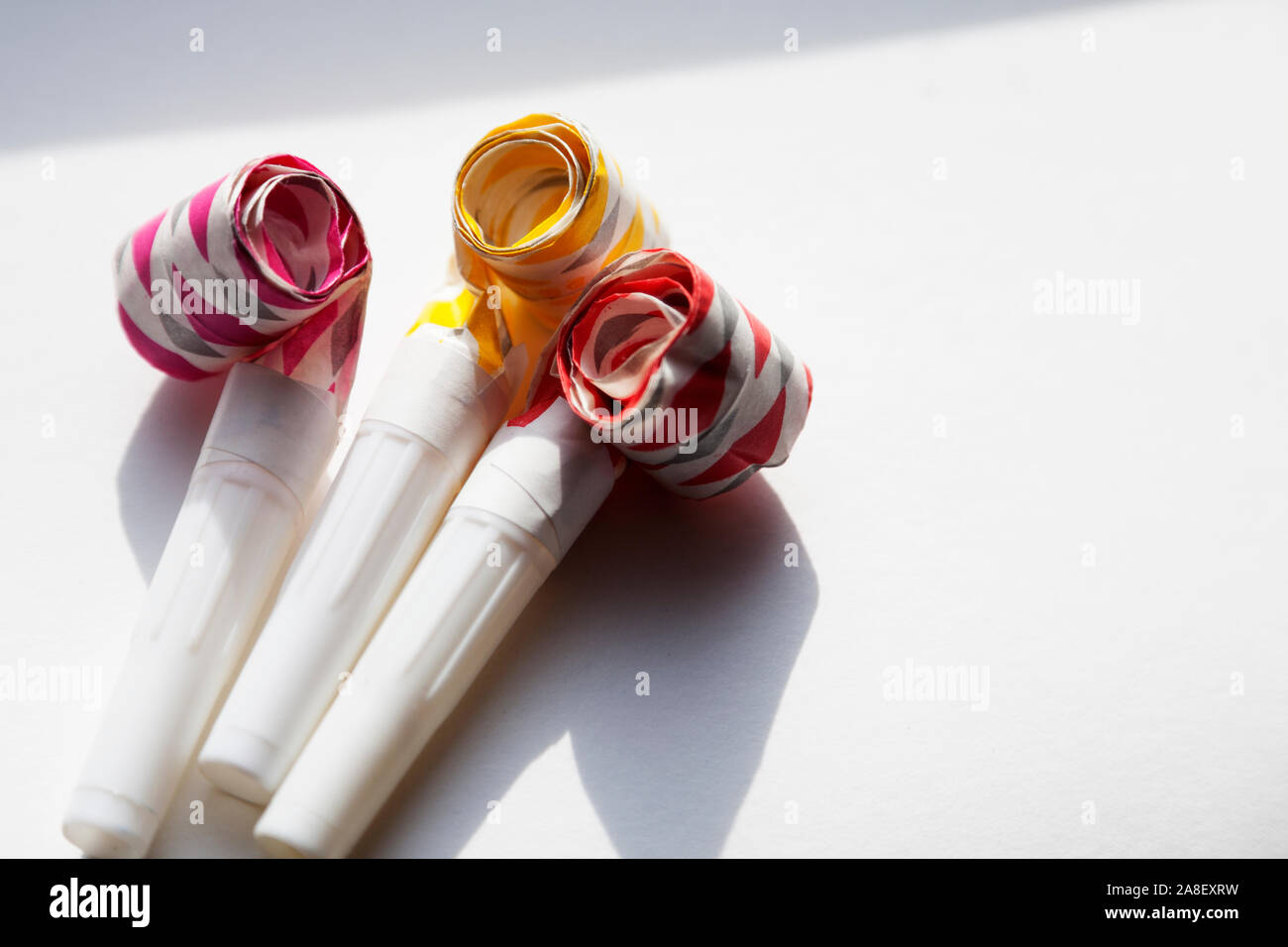 three party horns on white background, nice to have at New Year's party ...
