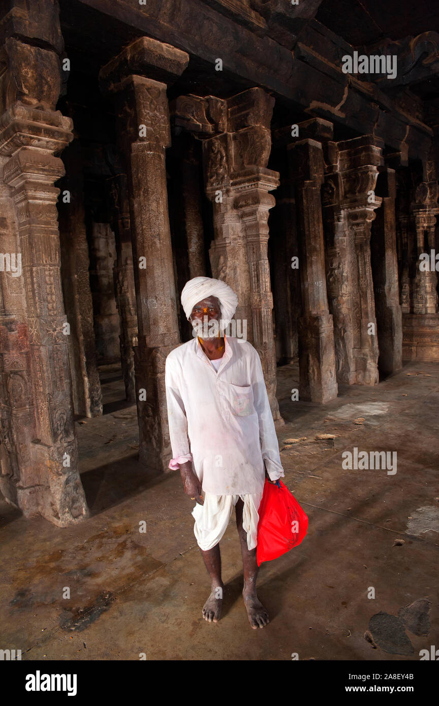 Indian man with white turban inside a temple at Hampi, Karnataka, India ...