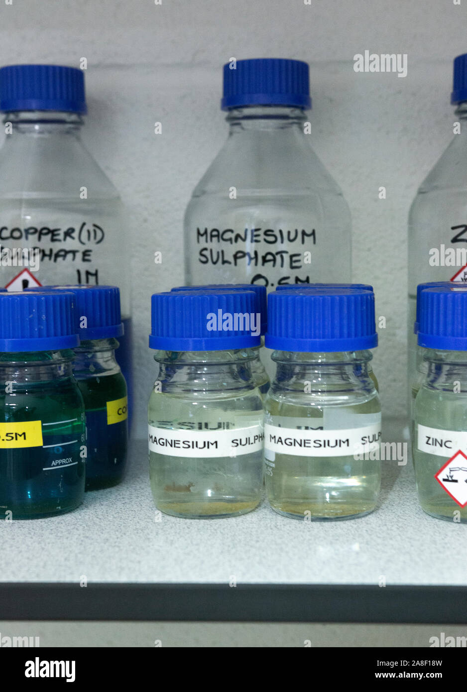 Magnesium sulphate solution in reagent bottles in a chemical store in ...