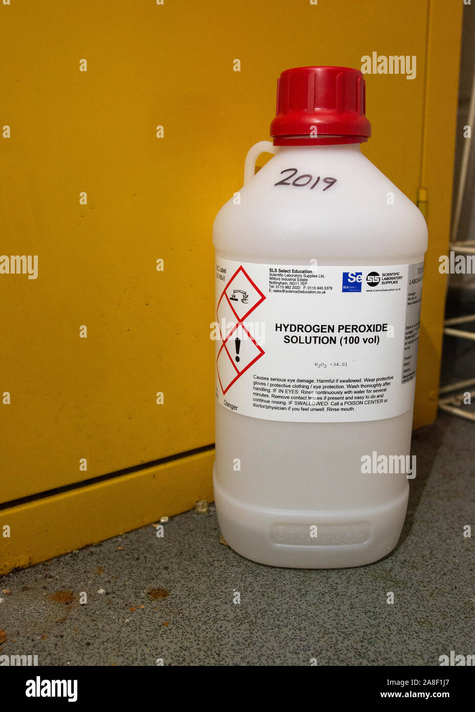 Stock bottle of hydrogen peroxide solution 100vol in a chemical store ...
