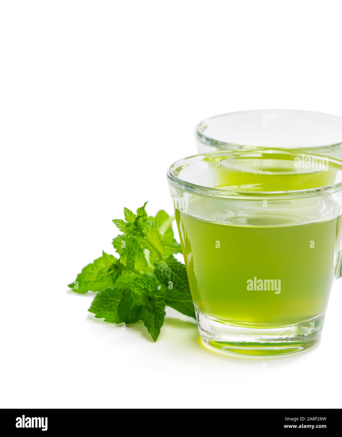 Green mint tea in clear glass cups isolated on white Stock Photo - Alamy