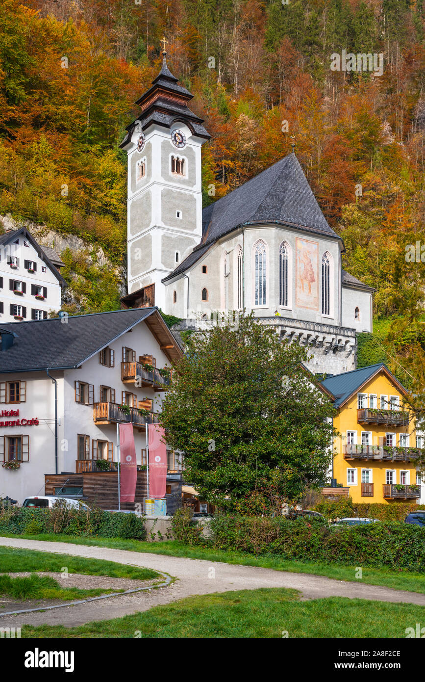 The Catholic parish church with fall foliage color in Hallstatt ...