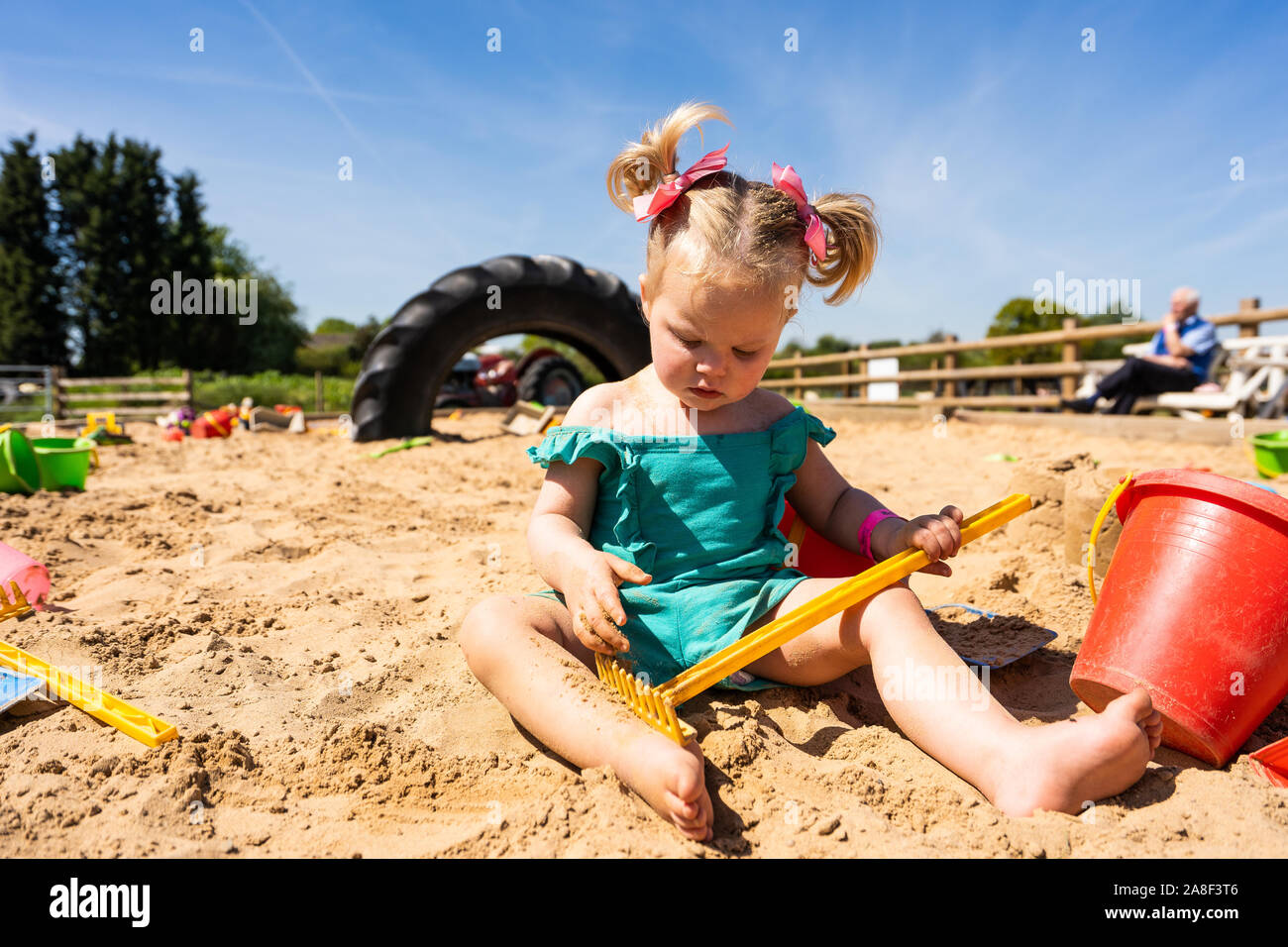 A little girl playing in the sandpit at Amerton Farm, a working family ...