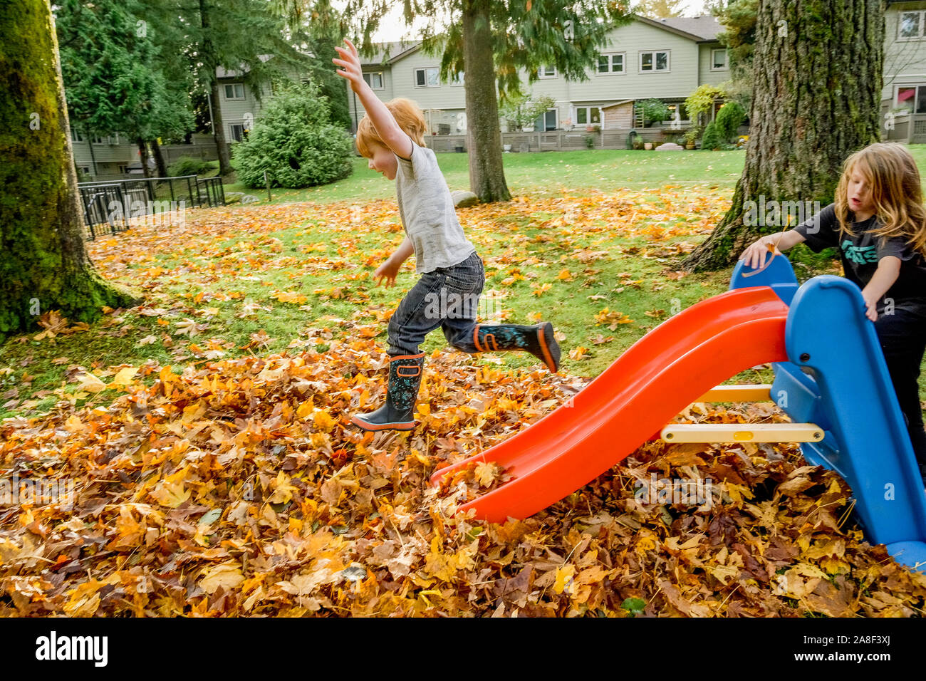 Kids playing on slide hi-res stock photography and images - Alamy