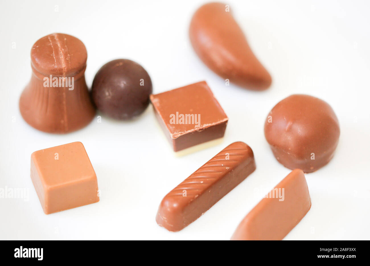 Yummy chocolate candies on white background - Image Stock Photo - Alamy
