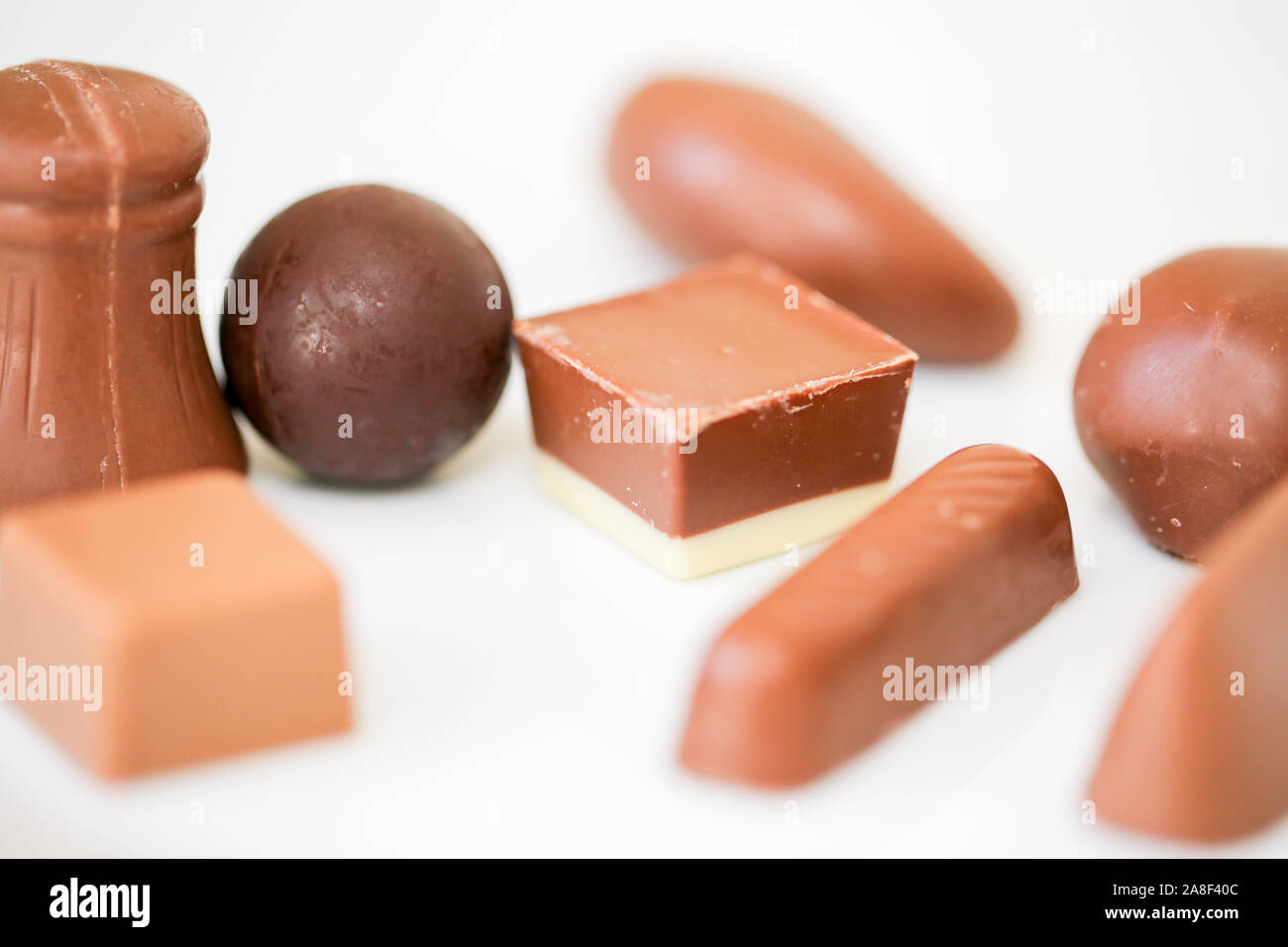 Yummy chocolate candies on white background - Image Stock Photo - Alamy
