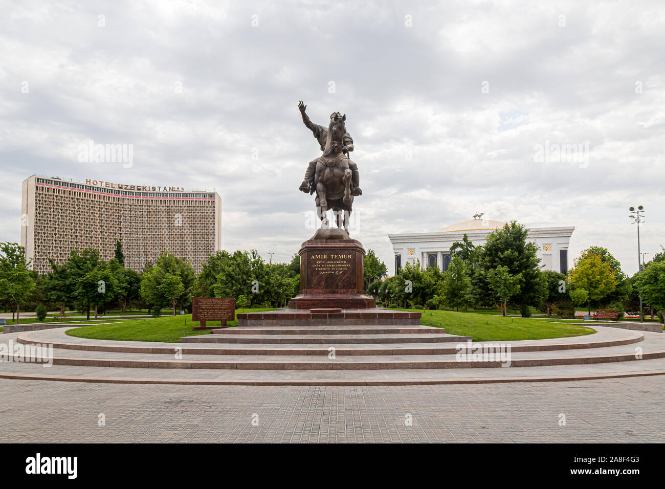 Statue of Amir Temur on horseback shown between the Uzbekistan Hotel ...