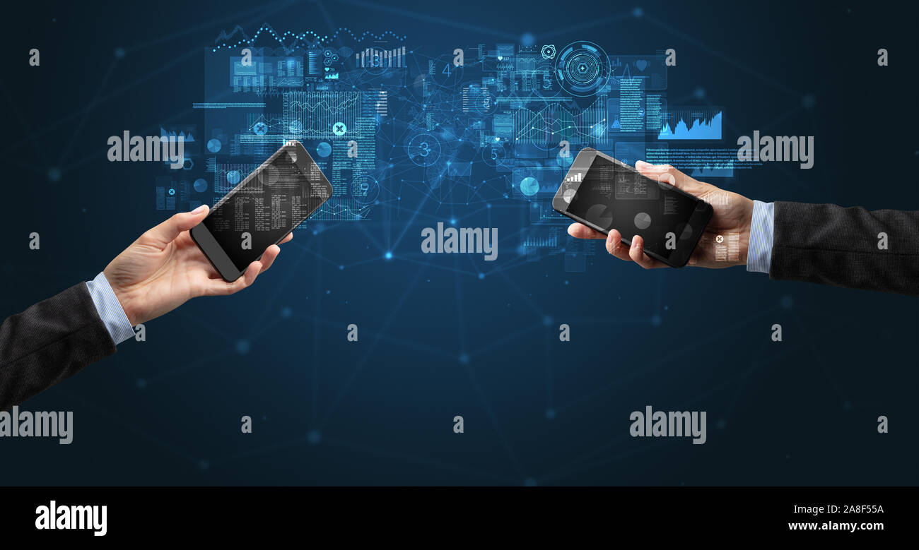 Close up of two hands holding smartphones to sync business data Stock ...