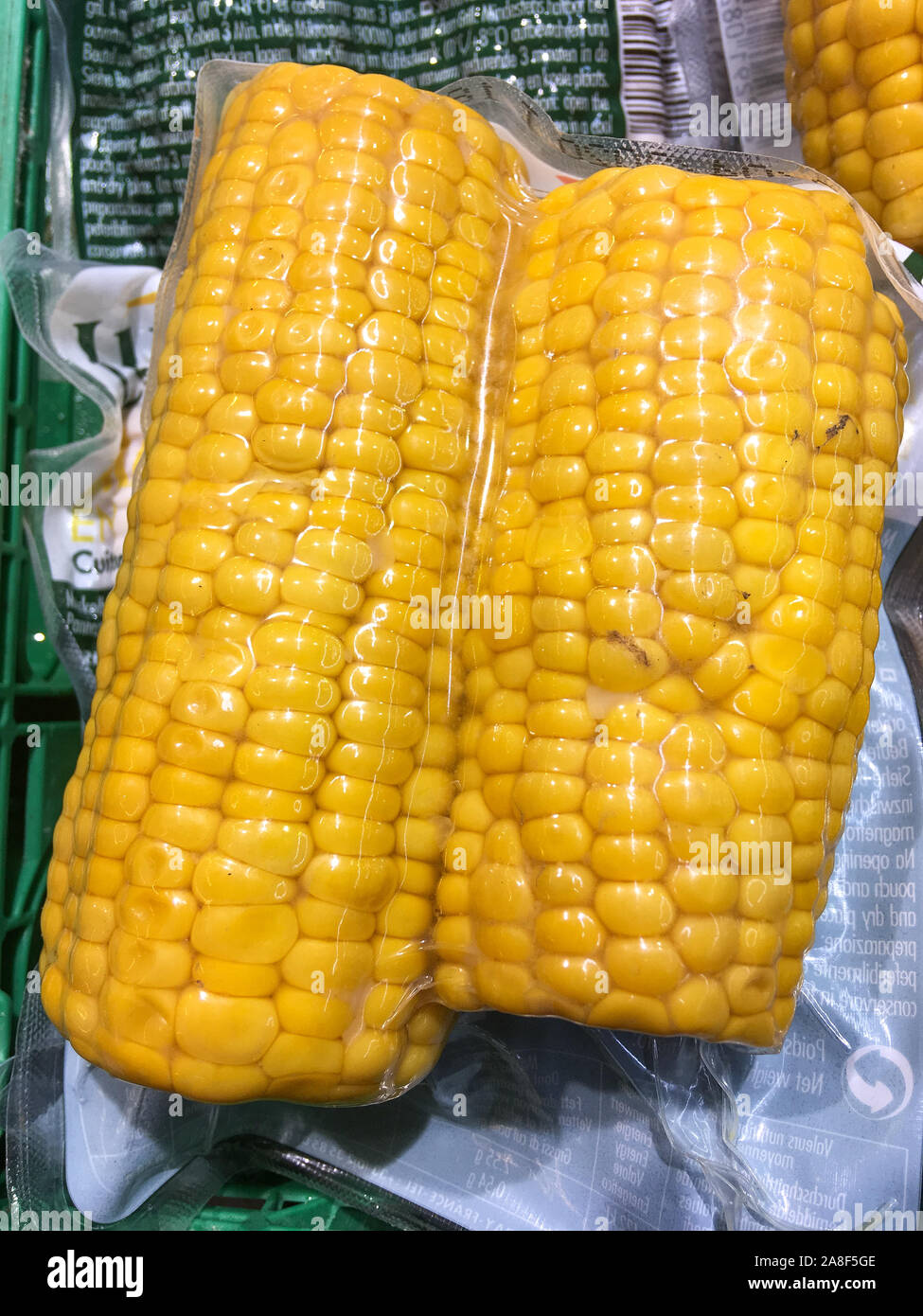 Corn cob under plastic package, Lyon, France Stock Photo - Alamy