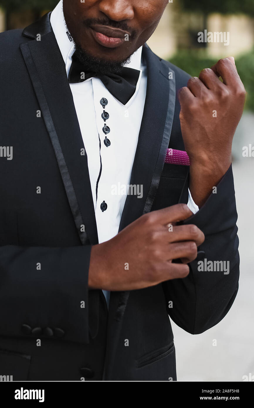 Afro american man wearing suit and standing near building Stock Photo ...