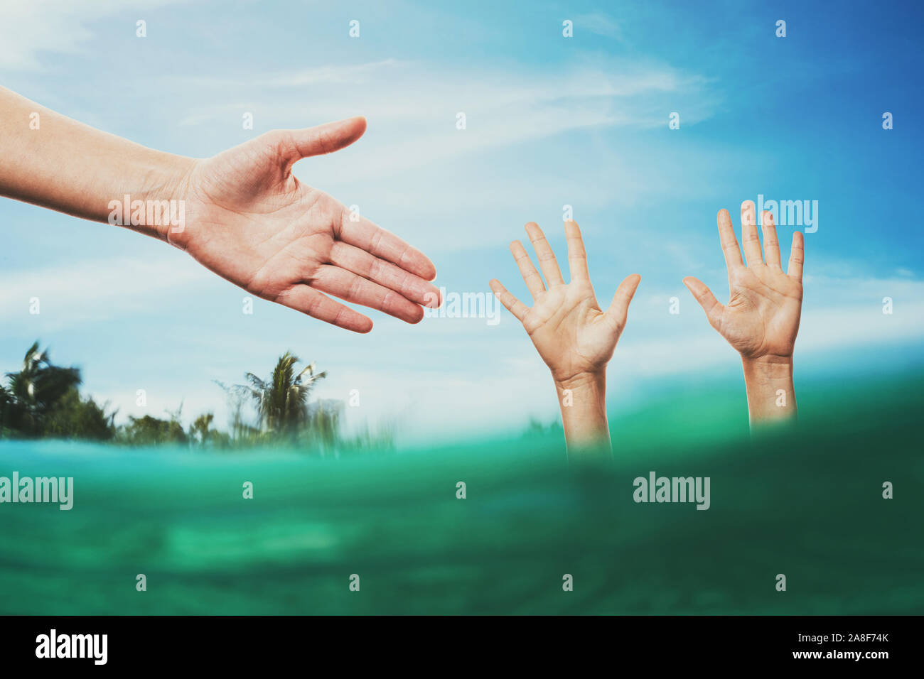 Saving the drowning. Helping hand pulls to sinking man in ocean Stock ...