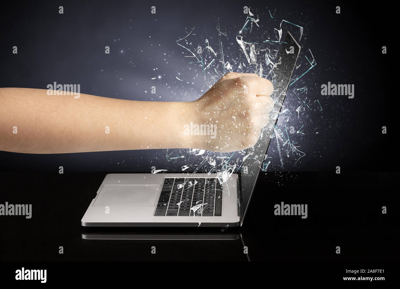 Hand hitting strongly laptop screen glass Stock Photo - Alamy