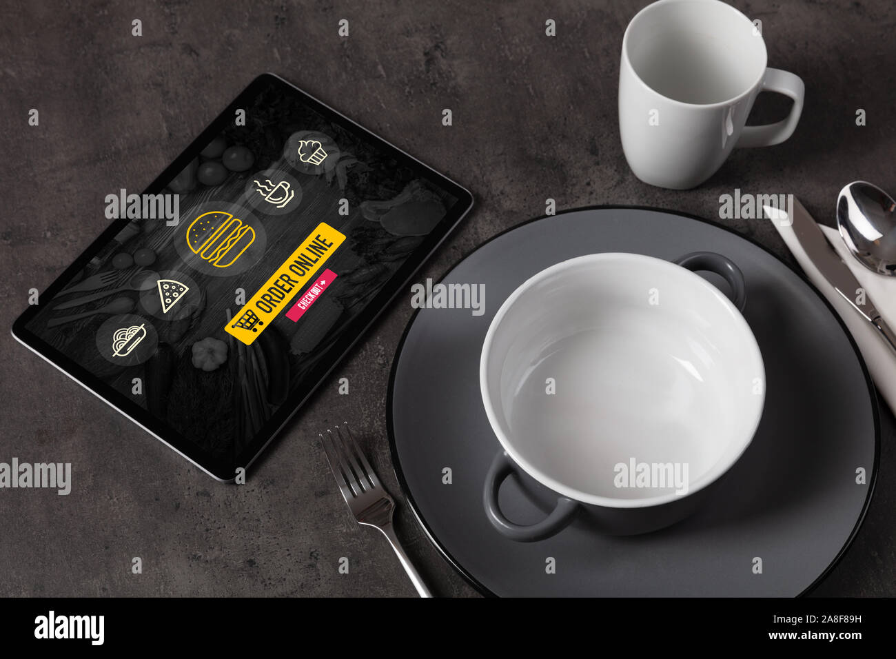 Online fast food order concept on a laid table Stock Photo - Alamy