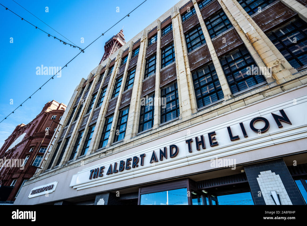 The world famous Blackpool Tower and beach surround by hotels, pubs and ...