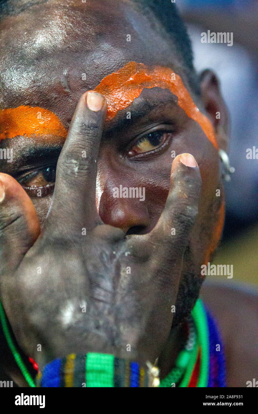 Hamer tribe warrior paints leopard marks on young man before bull ...