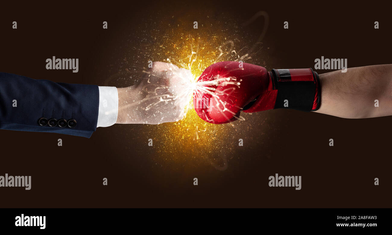 Two hands fighting with orange dust, spark, glow and smoke concept ...