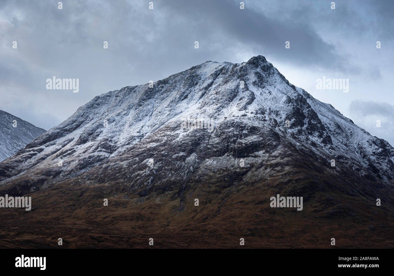 Snow capped mountain peak in Scottish highlands during season change ...
