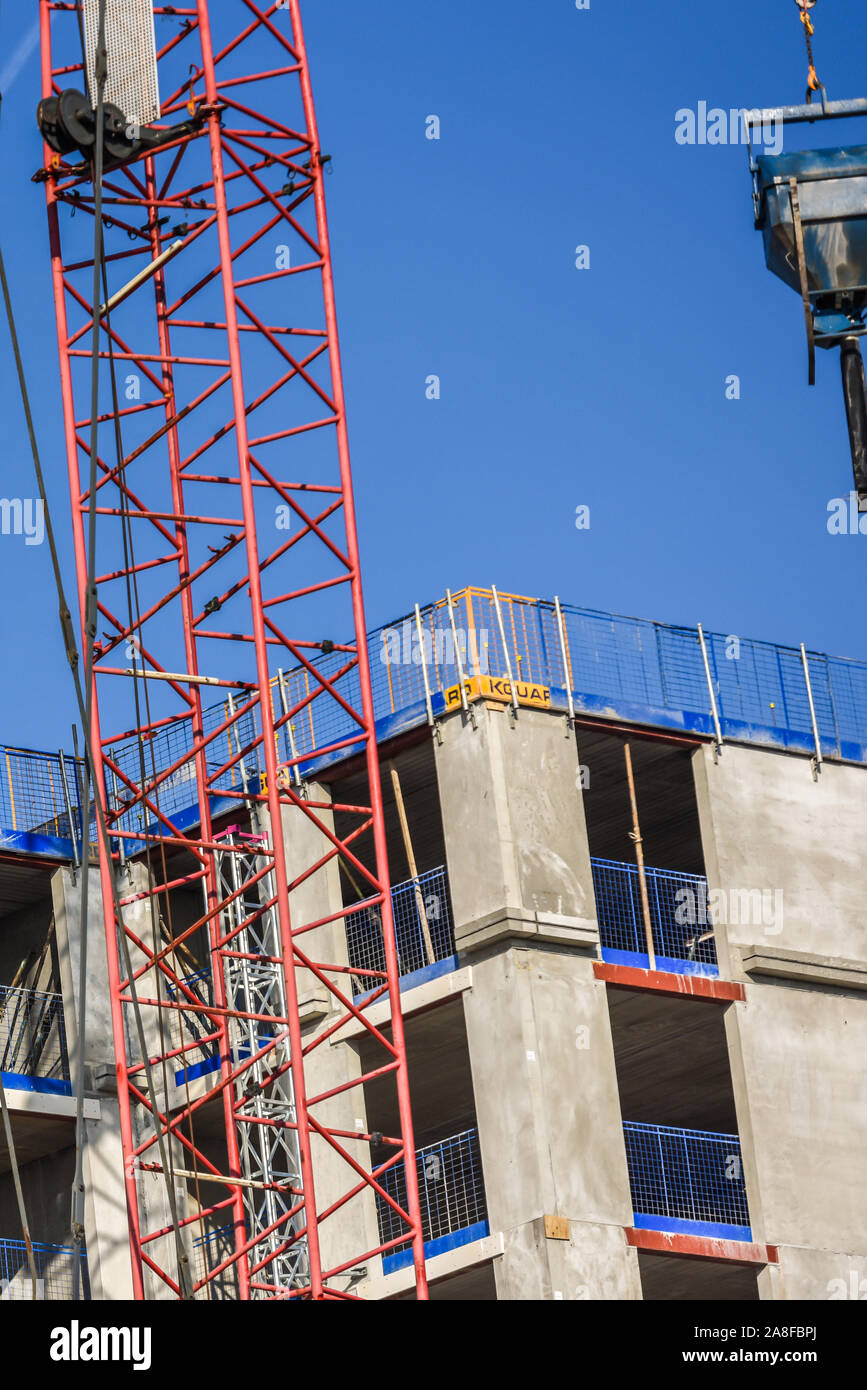 Workmen stand on the roof of a huge high rise Hilton Hotel development ...