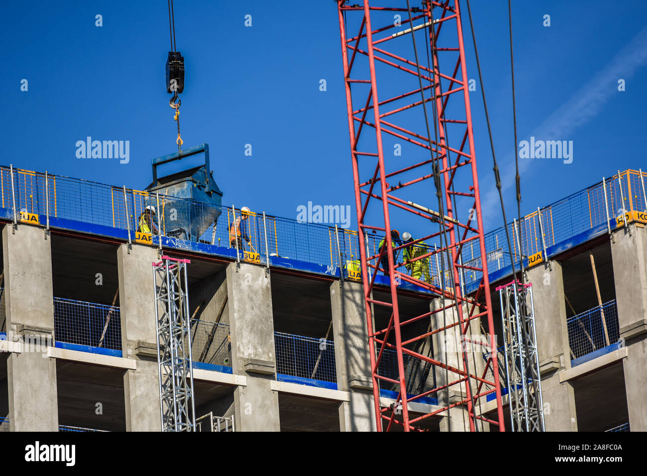 Workmen stand on the roof of a huge high rise Hilton Hotel development ...