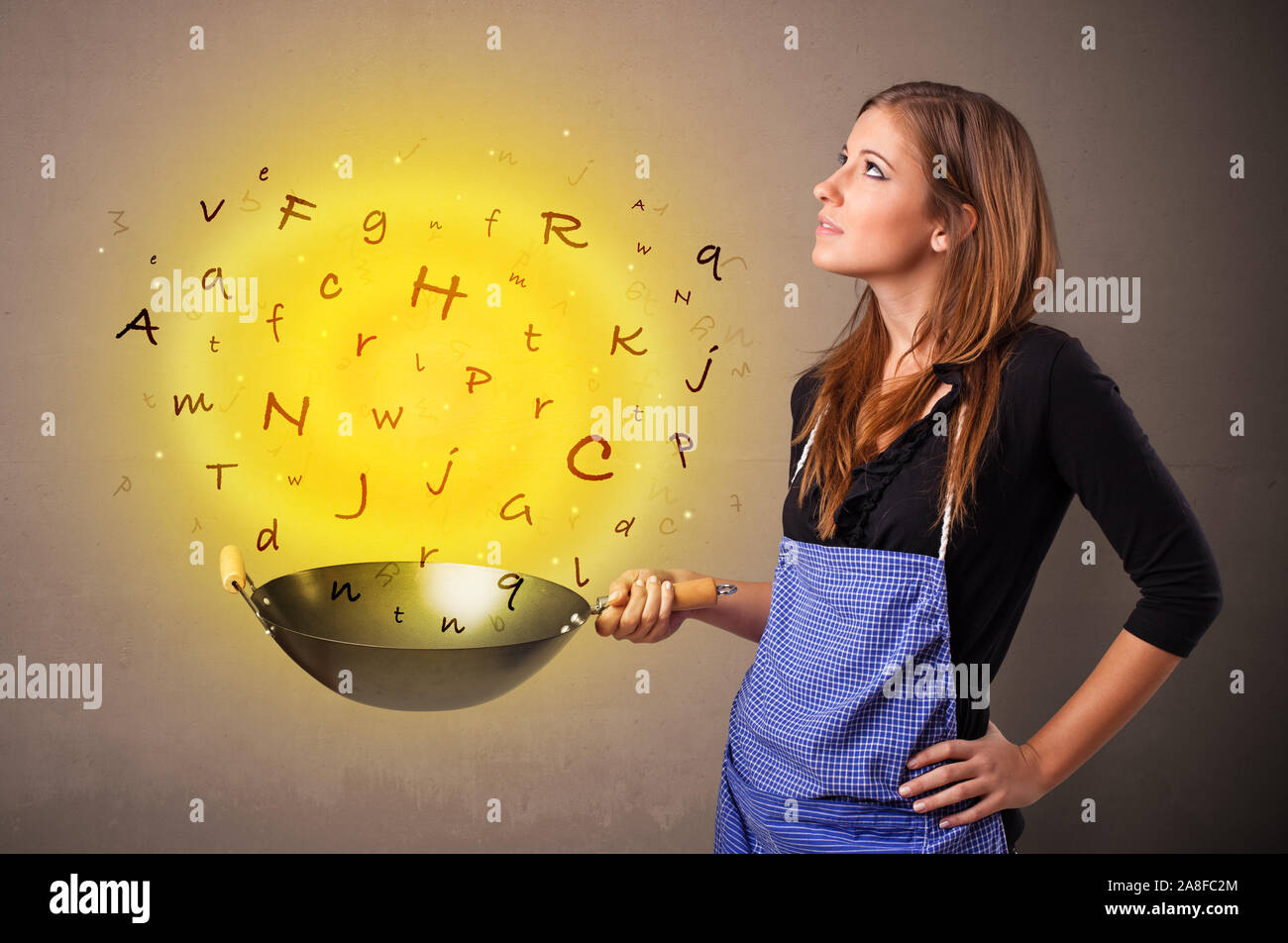 Young person cooking letters in wok Stock Photo - Alamy