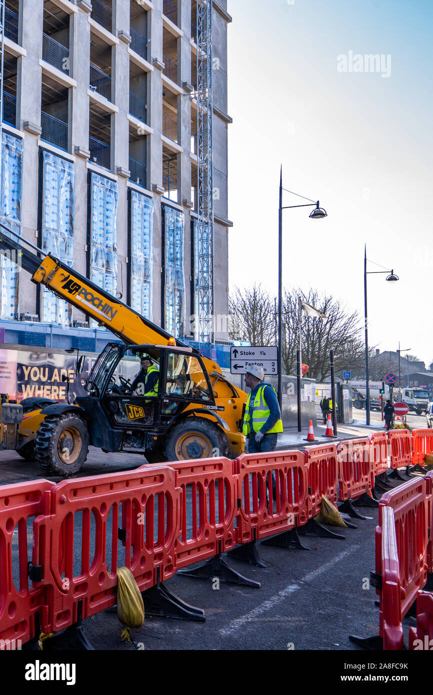 A JCB driver works on the new Hilton Hotel building, structure in Stoke ...