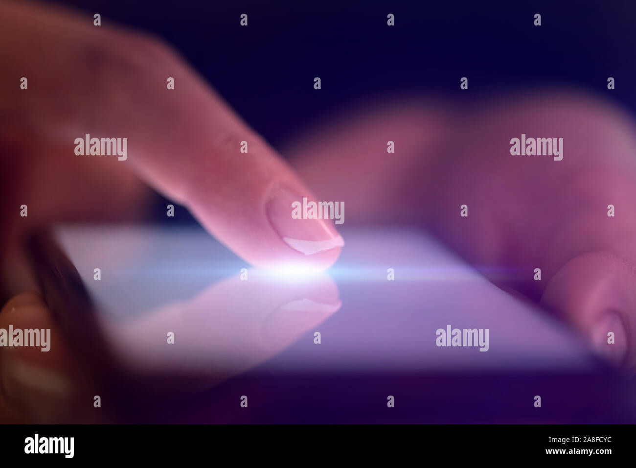 Finger touching phone with dark background with copyspace Stock Photo ...