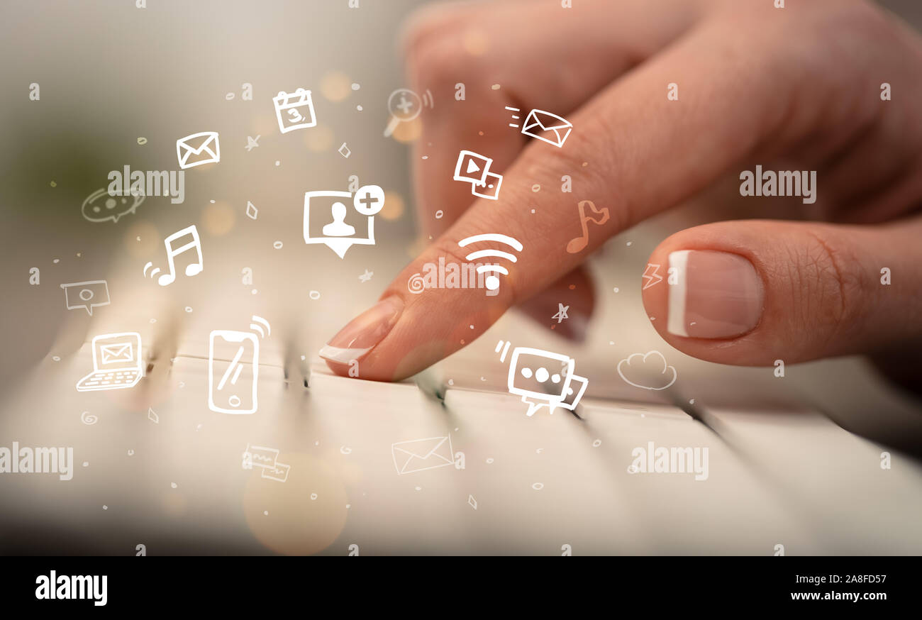 Business woman hand typing on keyboard with drawn application icons ...