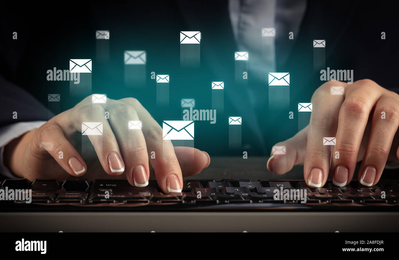 Business woman typing on keyboard with mail icons around Stock Photo ...