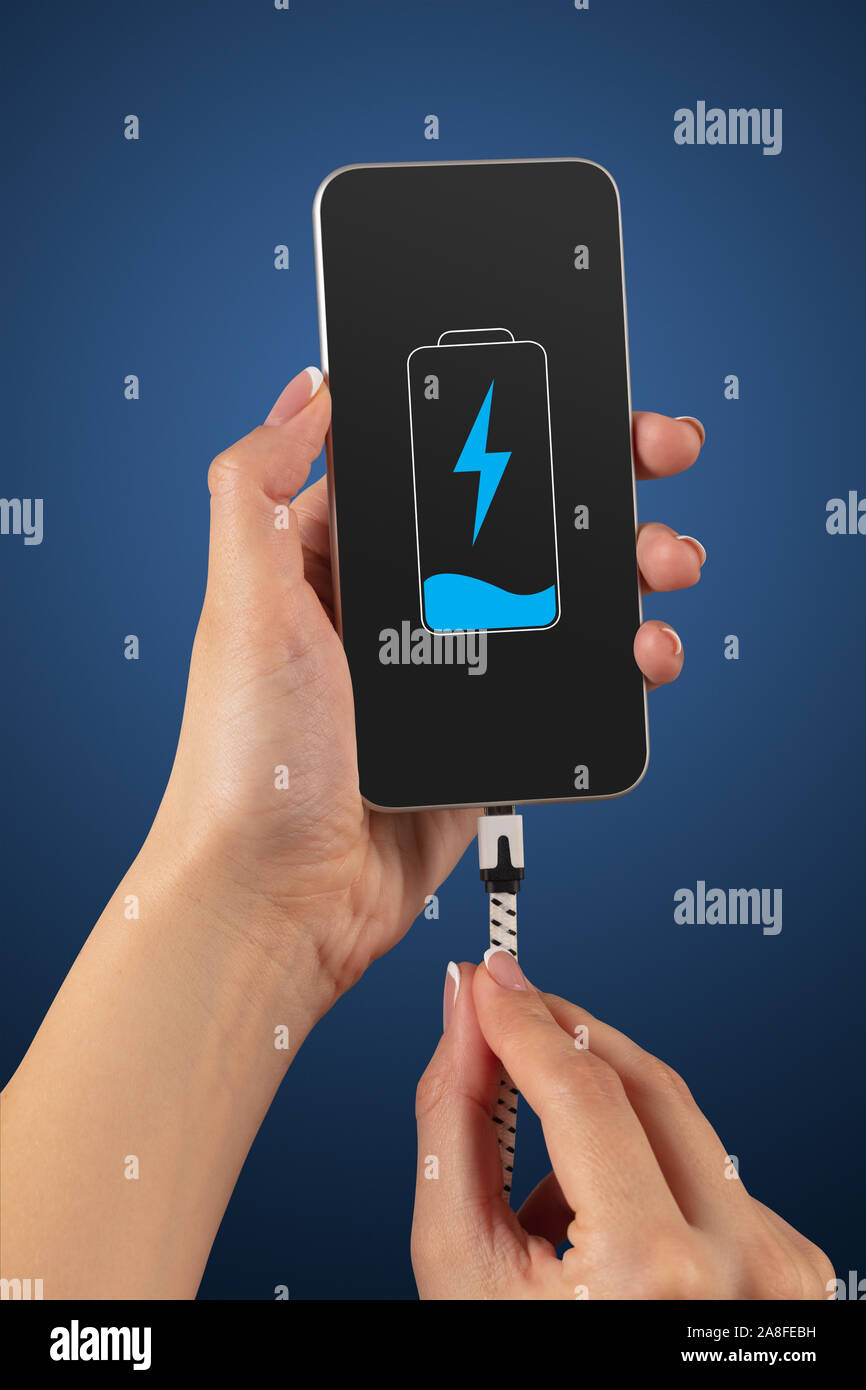 Elegant hand charging cellphone with low battery Stock Photo - Alamy