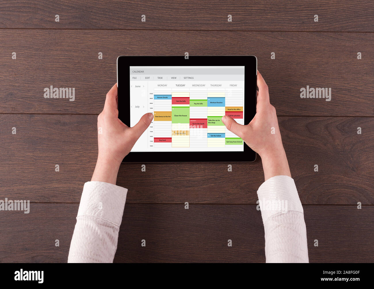 Hand holding tablet with timetable and calendar concept Stock Photo - Alamy