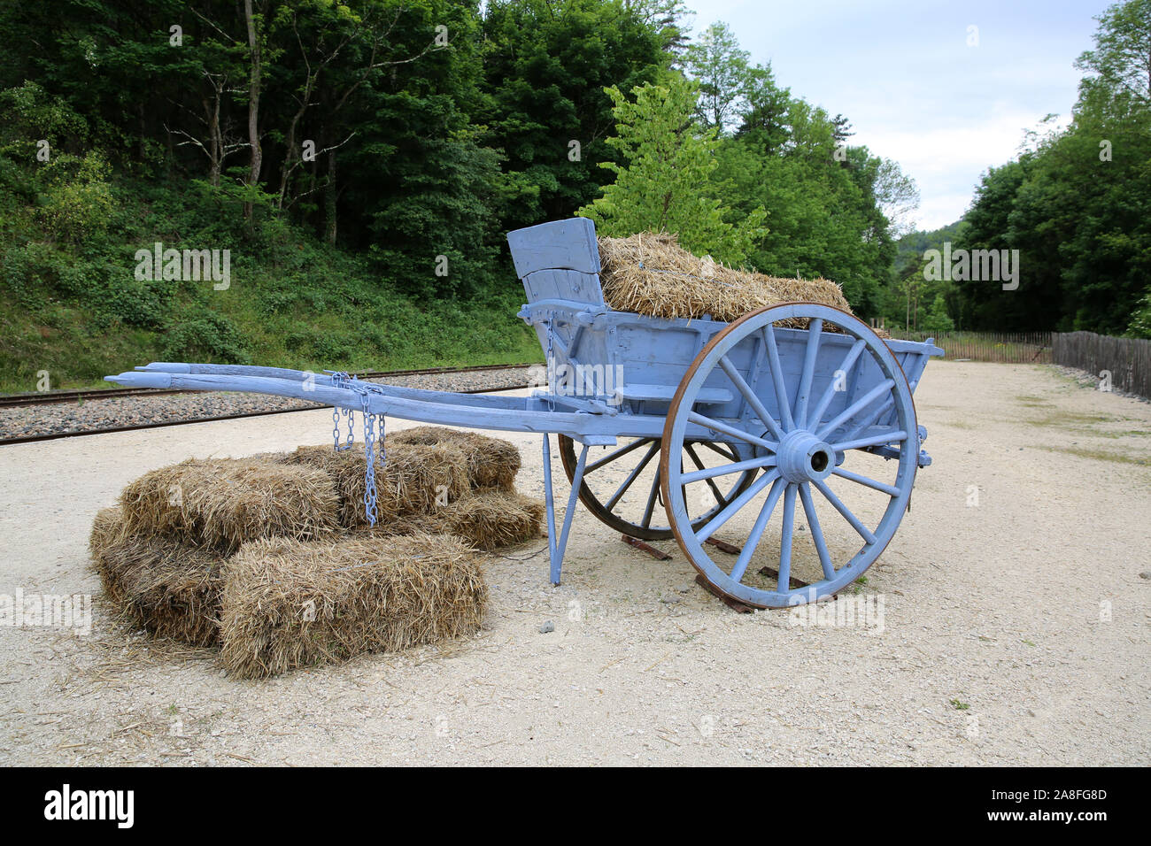 Blue hay cart and bales of hay, Ardeche, France Stock Photo - Alamy