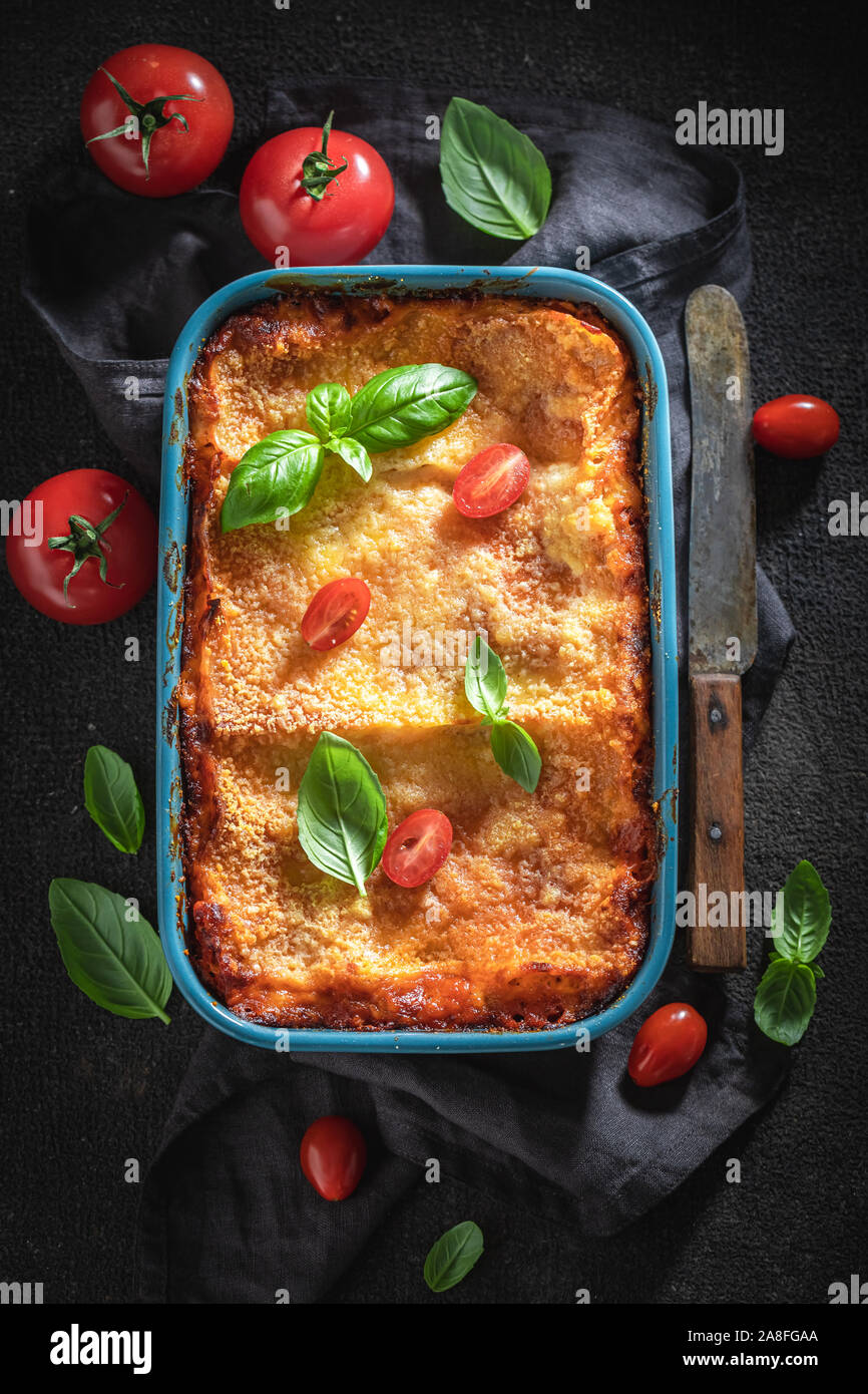 Hot lasagna with bechamel sauce, tomatoes and herbs Stock Photo - Alamy