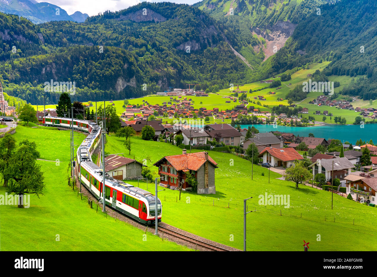 Famous electric red tourist panoramic train in swiss village Lungern ...