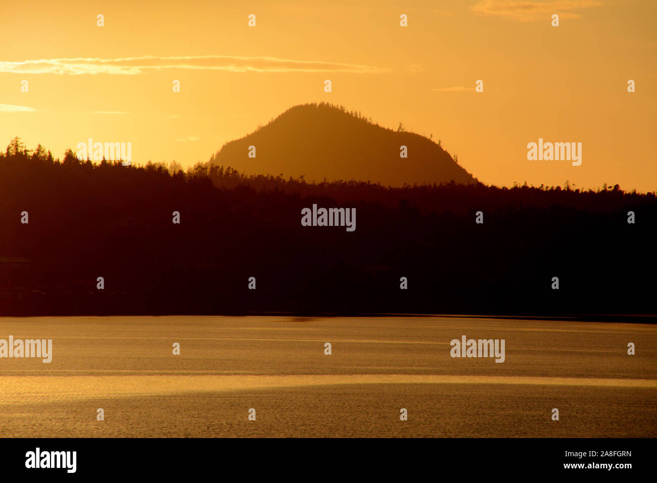 The sunset behind the Heiltsuk First Nation community of Bella Bella ...