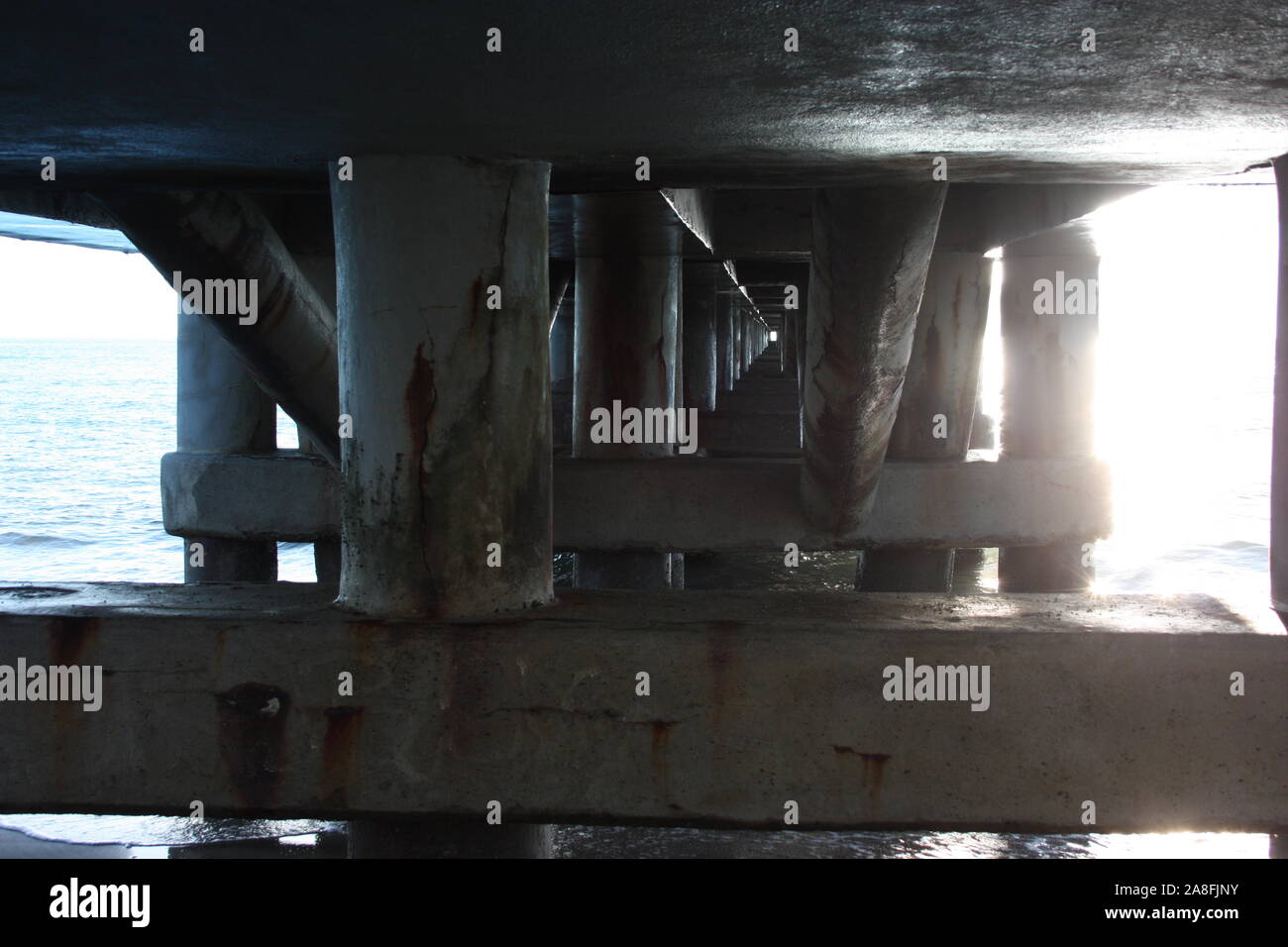 pylons bearing a pier on the sea in Italy, Tuscany Stock Photo - Alamy