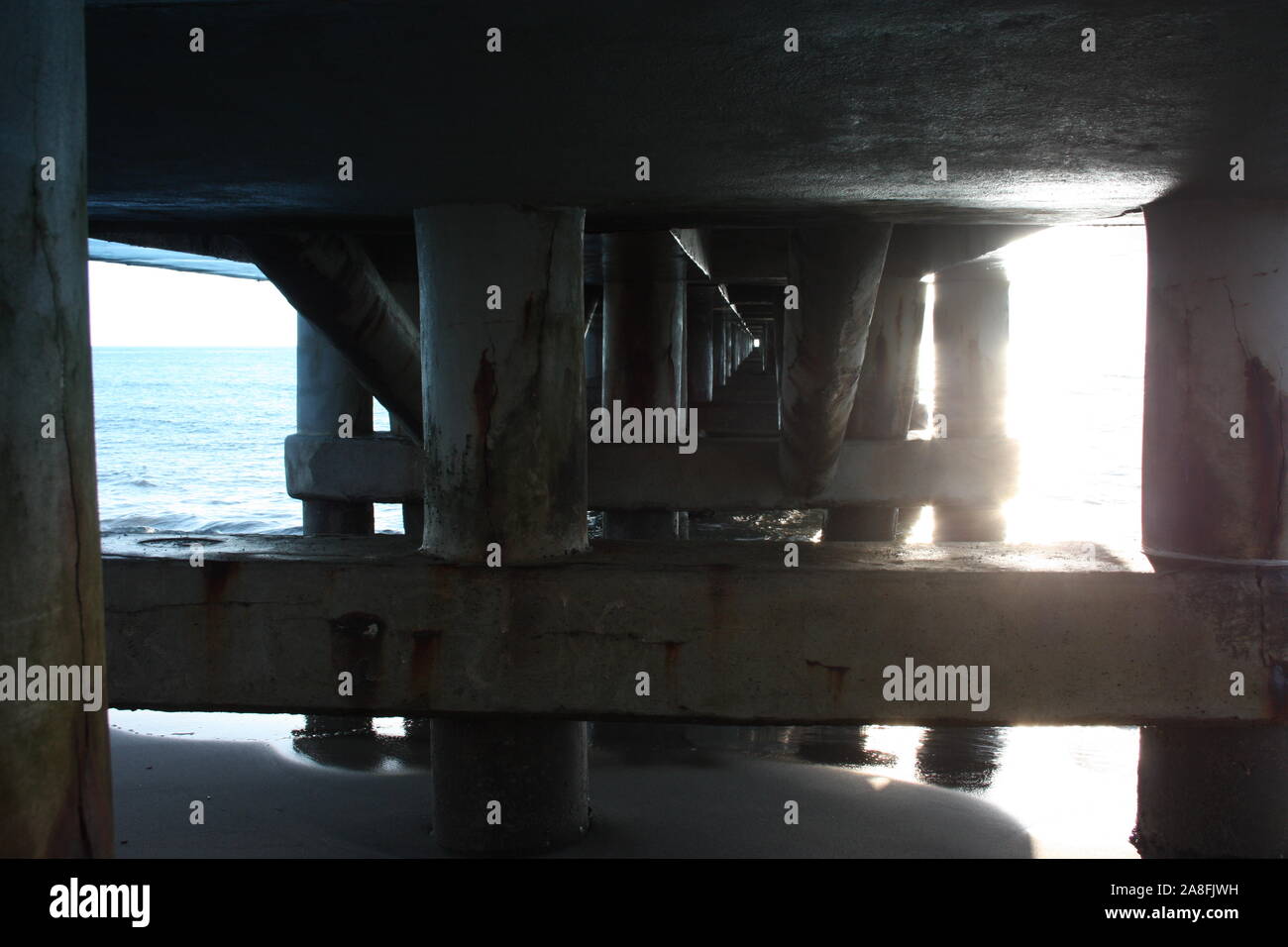 pylons bearing a pier on the sea in Italy, Tuscany Stock Photo - Alamy