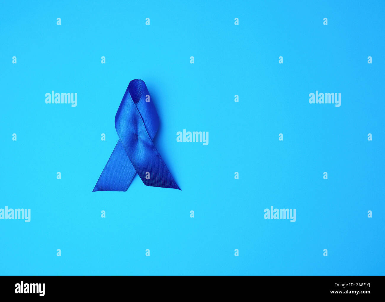 Dark blue awareness ribbon on blue background. concept of timely ...