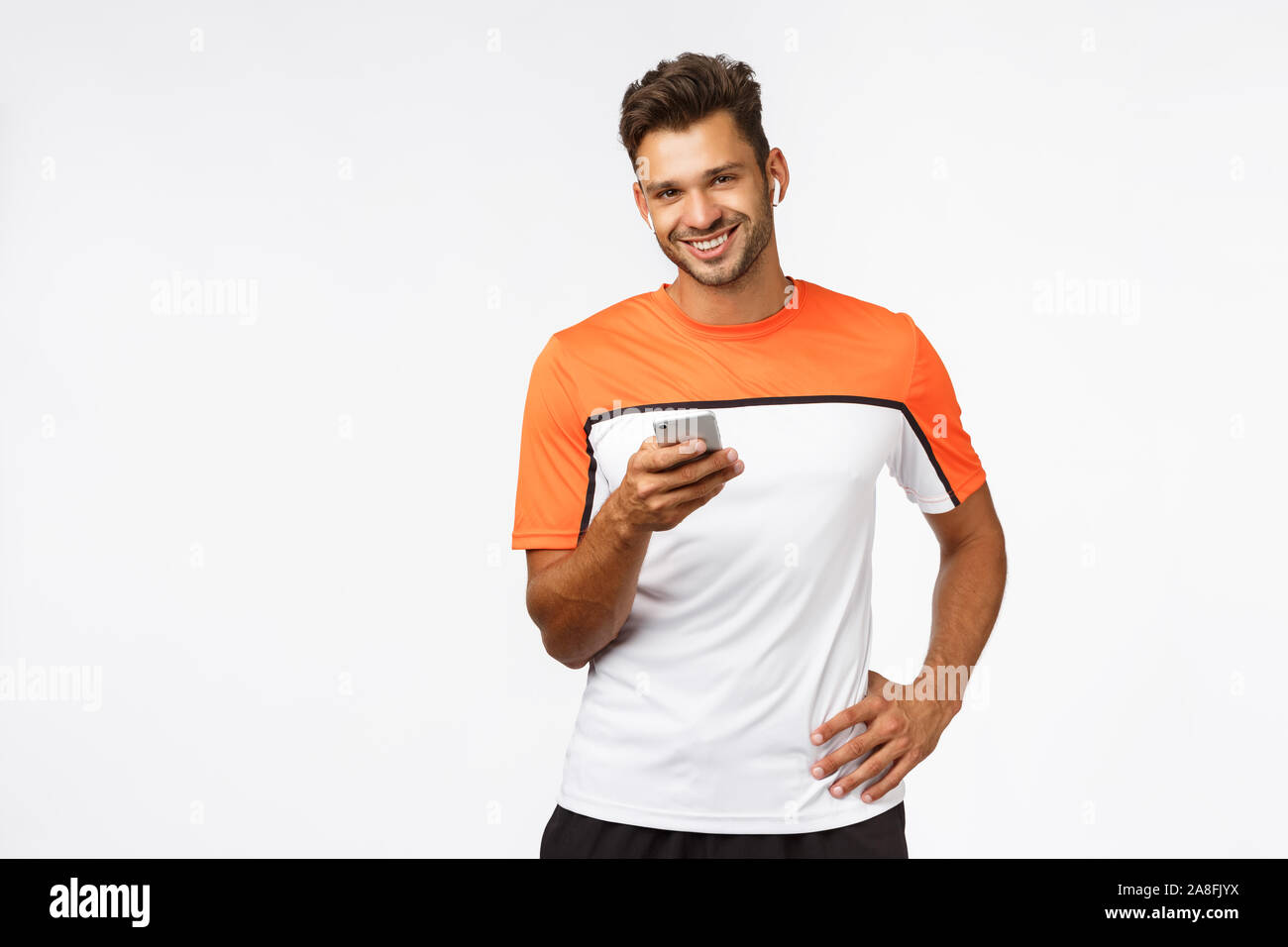 Technology, music and sport concept. Attractive smiling man listen ...