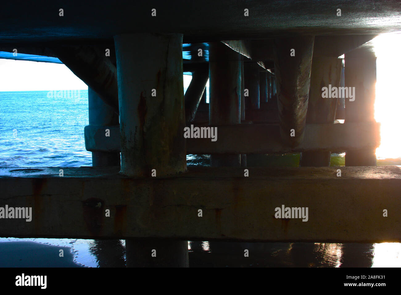 pylons bearing a pier on the sea in Italy, Tuscany Stock Photo - Alamy