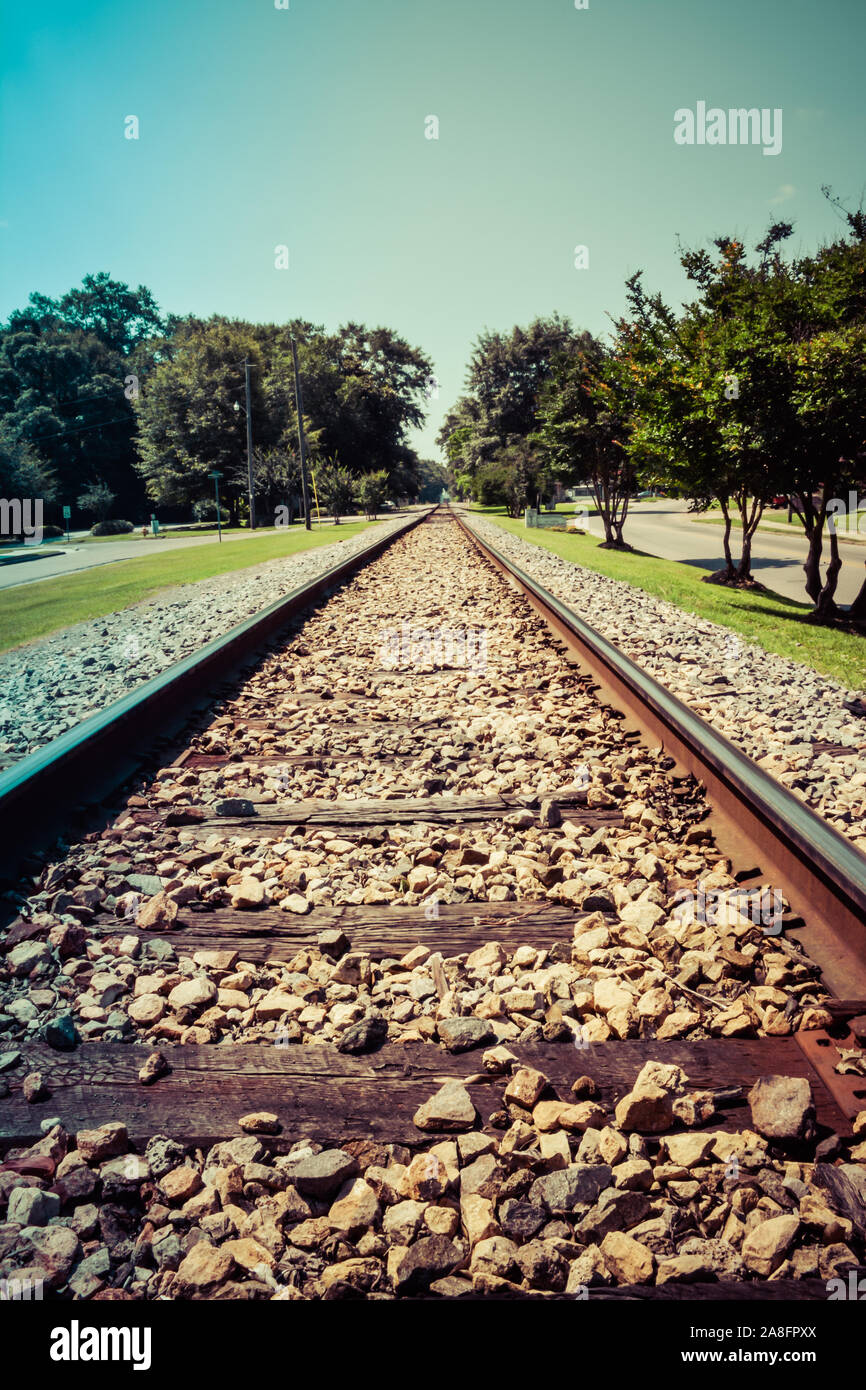 A diminishing perspective view down a straight railroad track into a ...