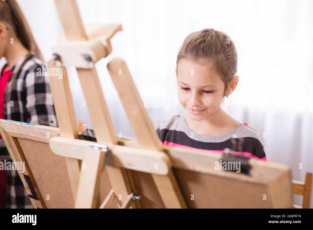 children draw on an easel in art school Stock Photo - Alamy