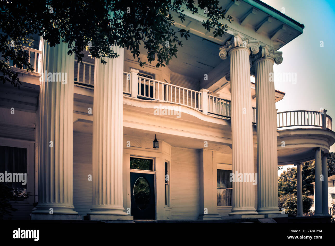 Ionic columns and a round veranda are highlights of this Greek Revival ...