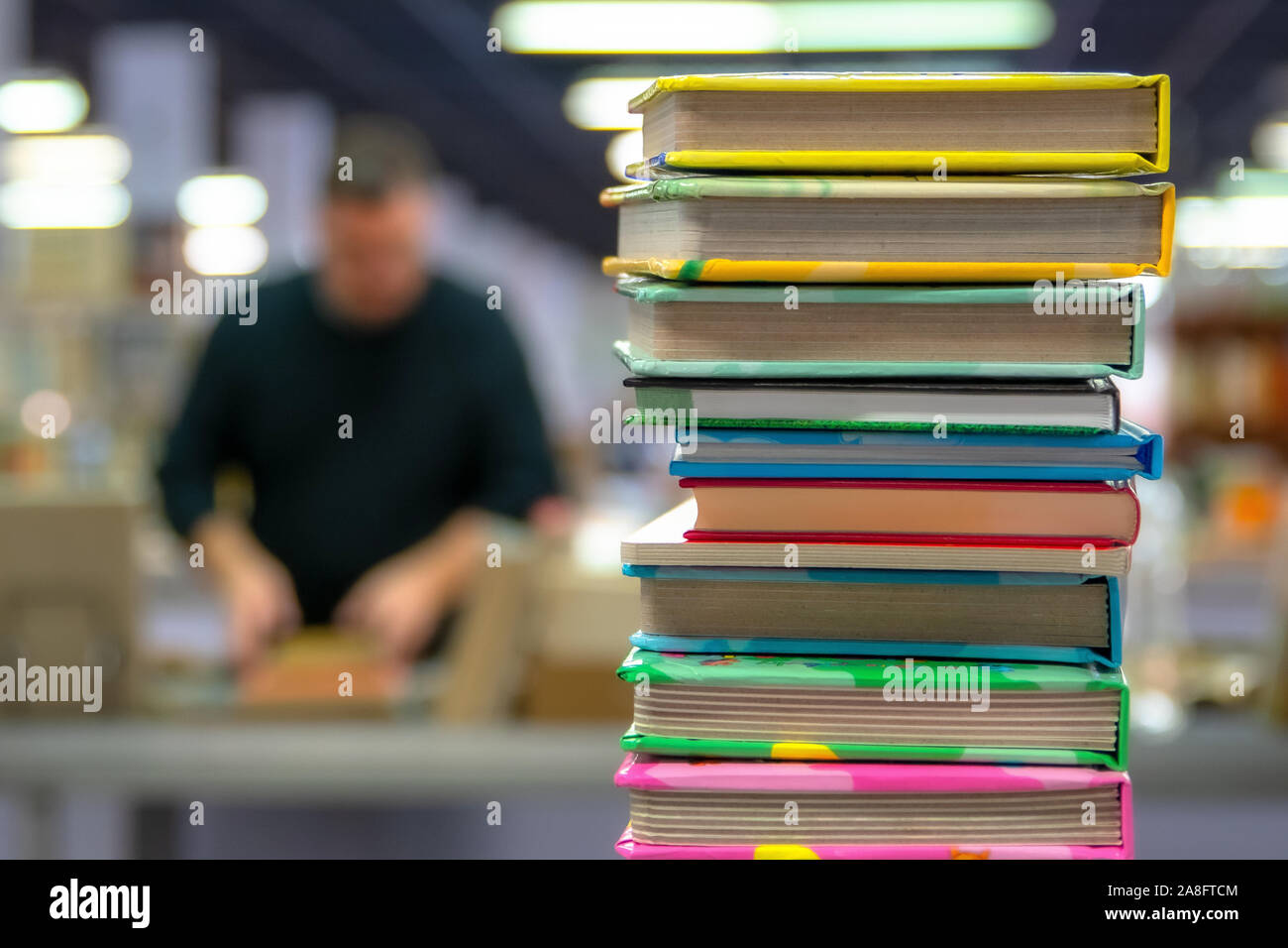 A stack of books on the blurred background of the bookstore. The ...