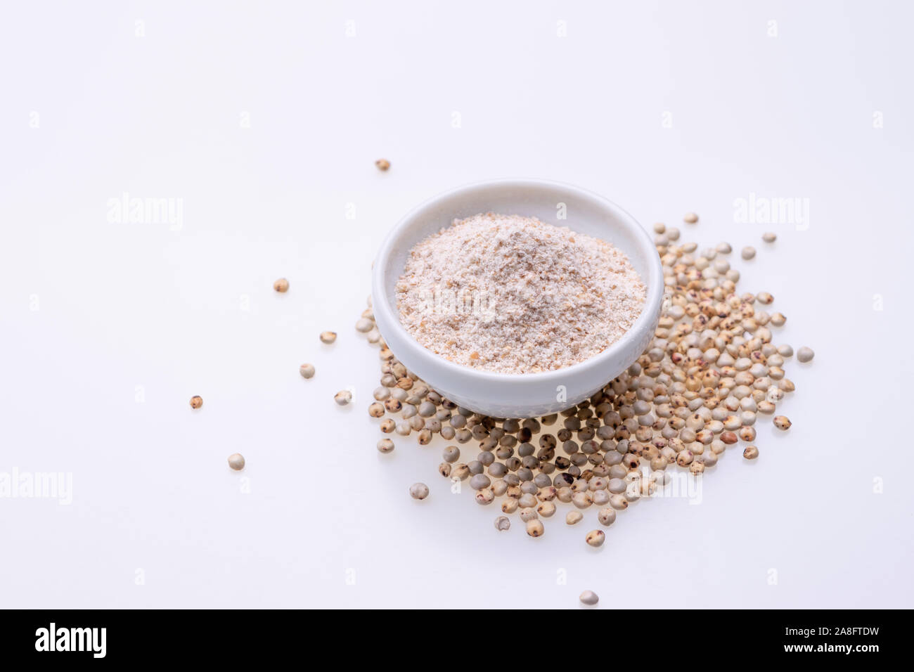 Uncooked raw Sorghum flour (also known as sorgo) in a white bowl ...