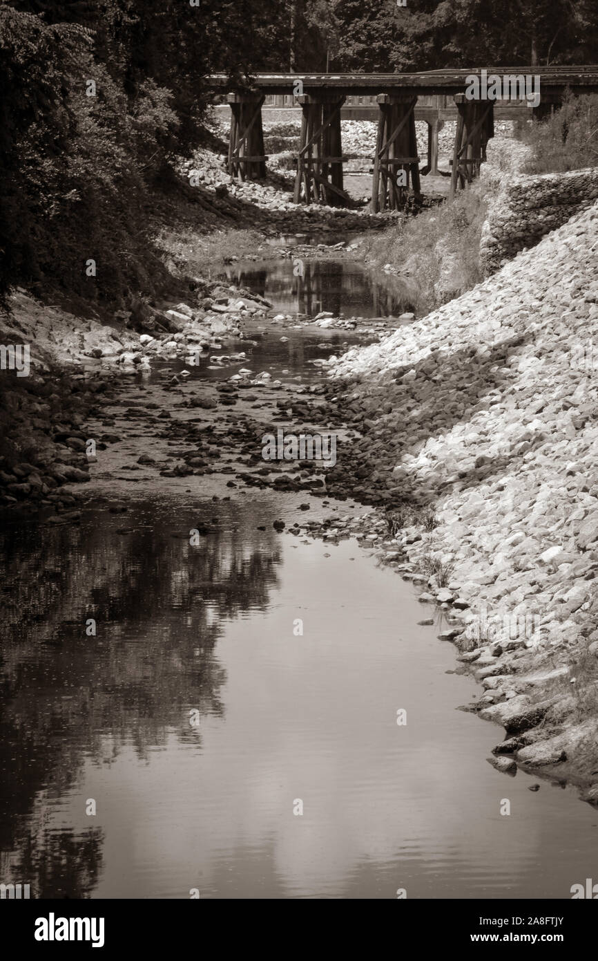 A distant Railroad track across a rickety wooden trestle with ...