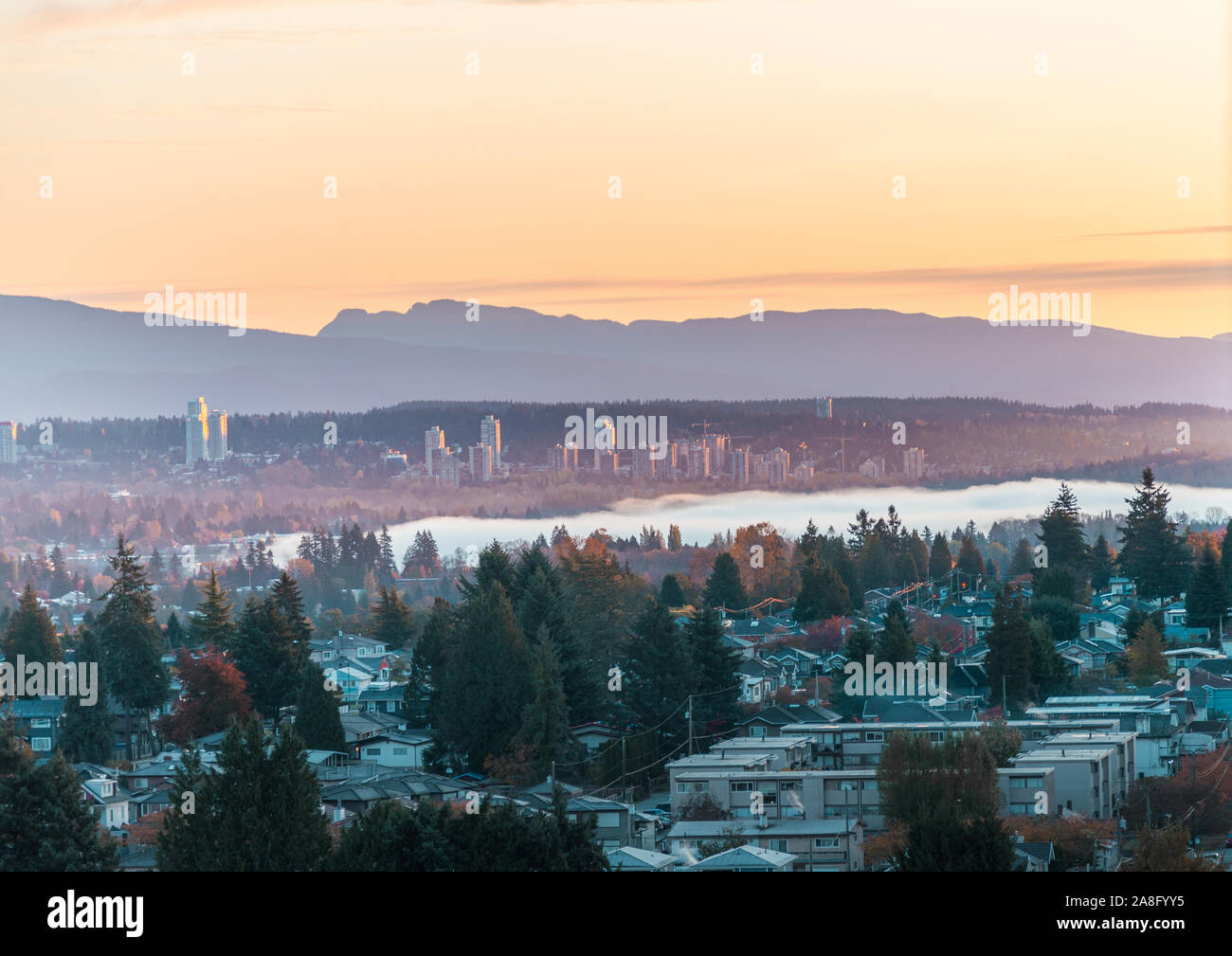 Autumn sunrise over Burnaby with scenic mountains backdrop and fog ...