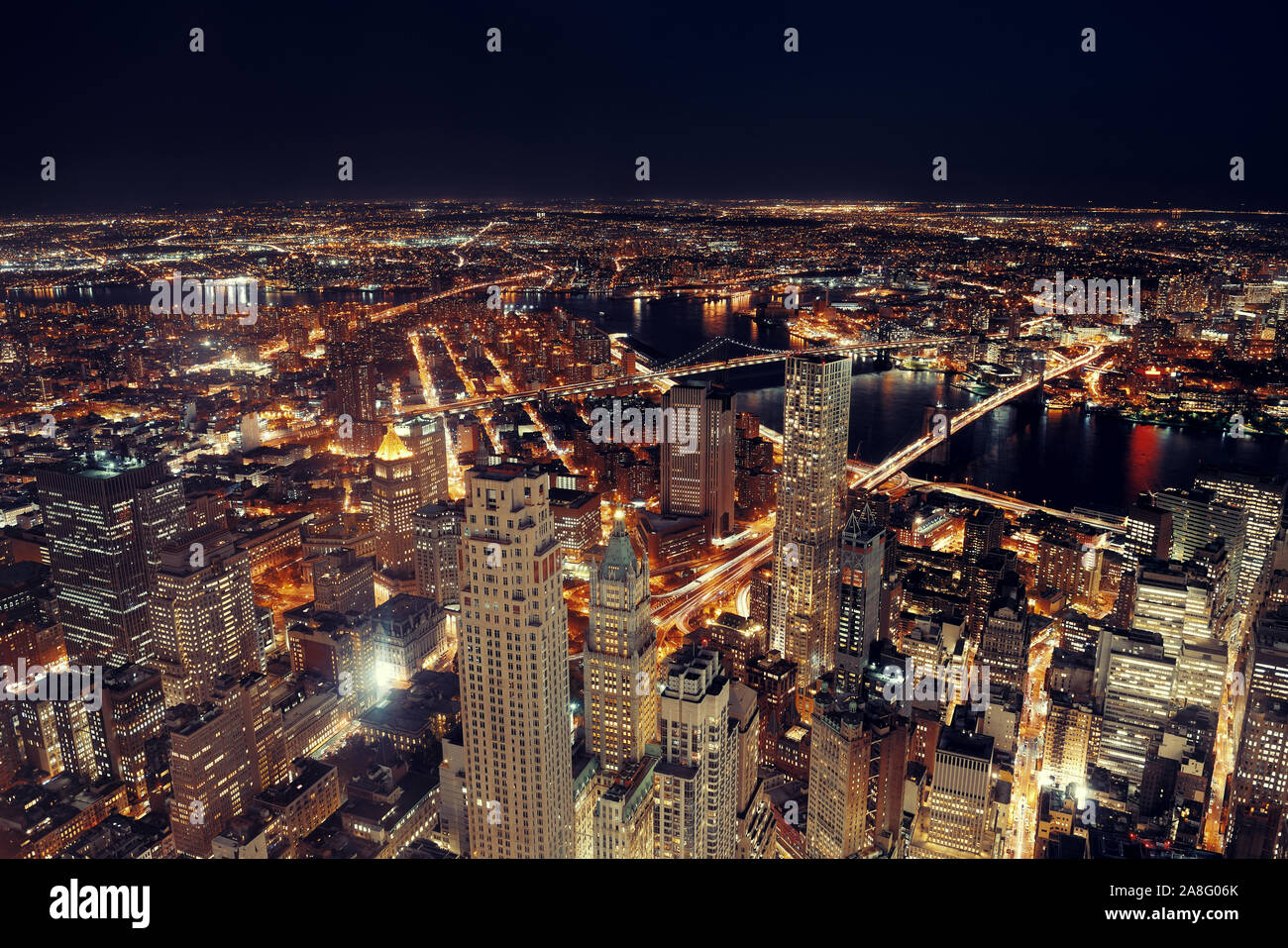 Rooftop night view of New York City downtown with urban skyscrapers ...