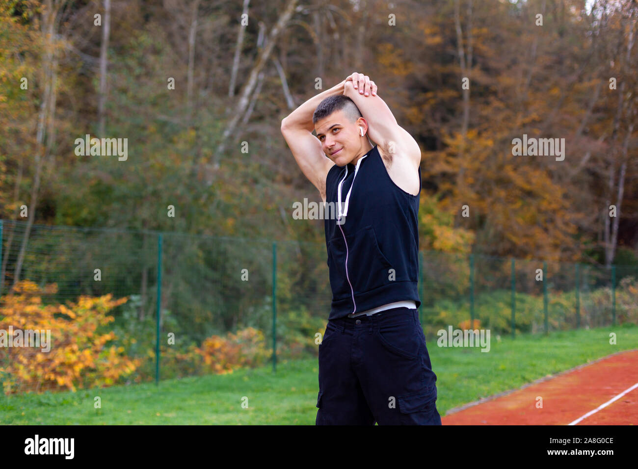 Young man stretching and warming up in the morning outdoor on the ...